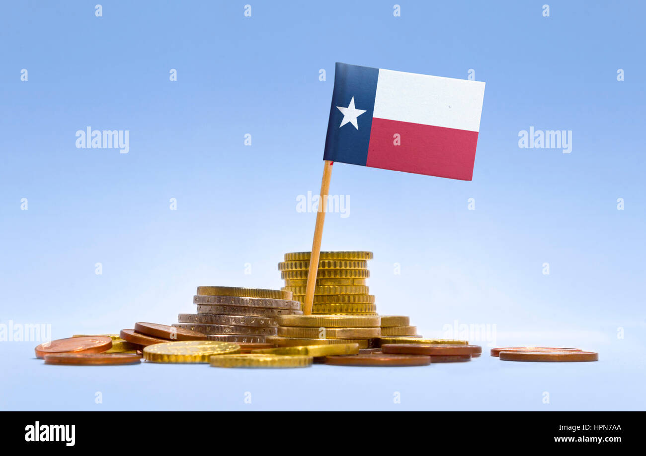 Flag of Texas in a mixed stack of european coins and a blue background ...
