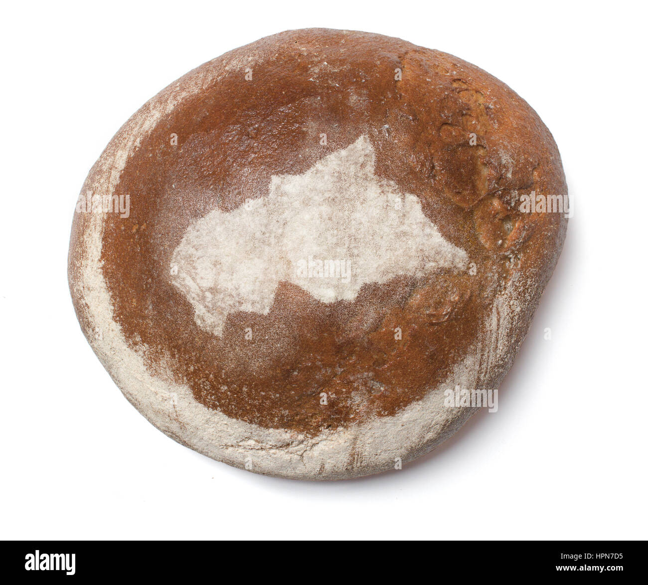 A freshly baked loaf of bread covered with rye flour in the shape of ...