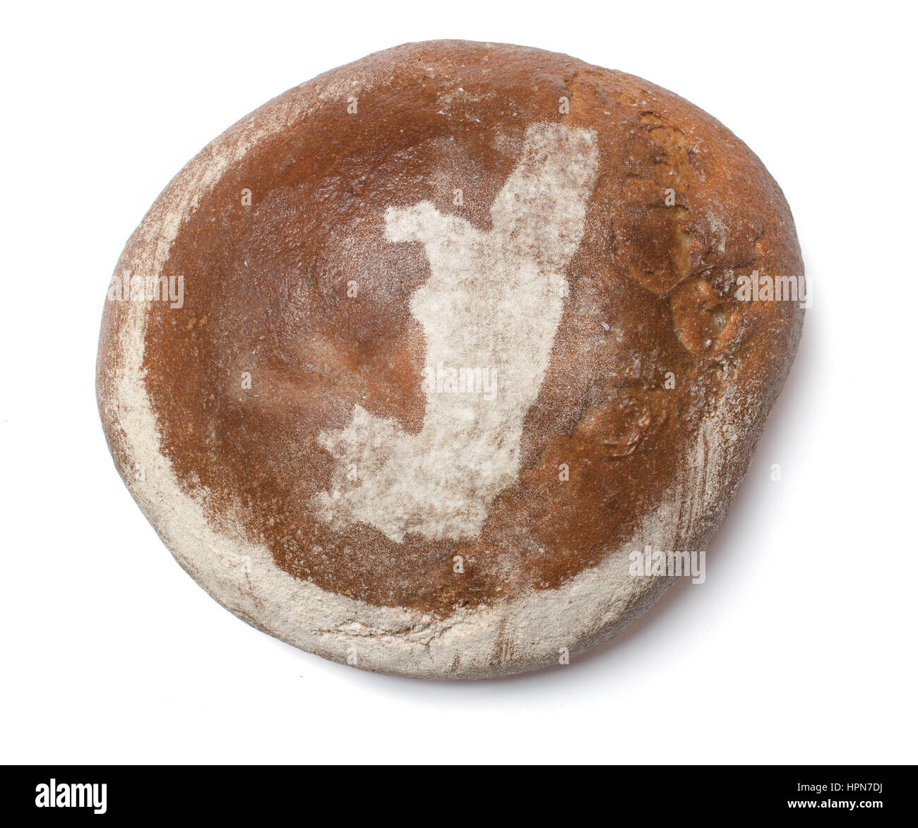 A freshly baked loaf of bread covered with rye flour in the shape of ...