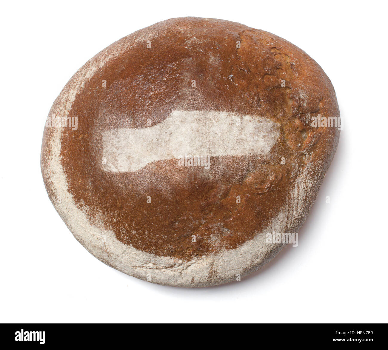 A freshly baked loaf of bread covered with rye flour in the shape of ...