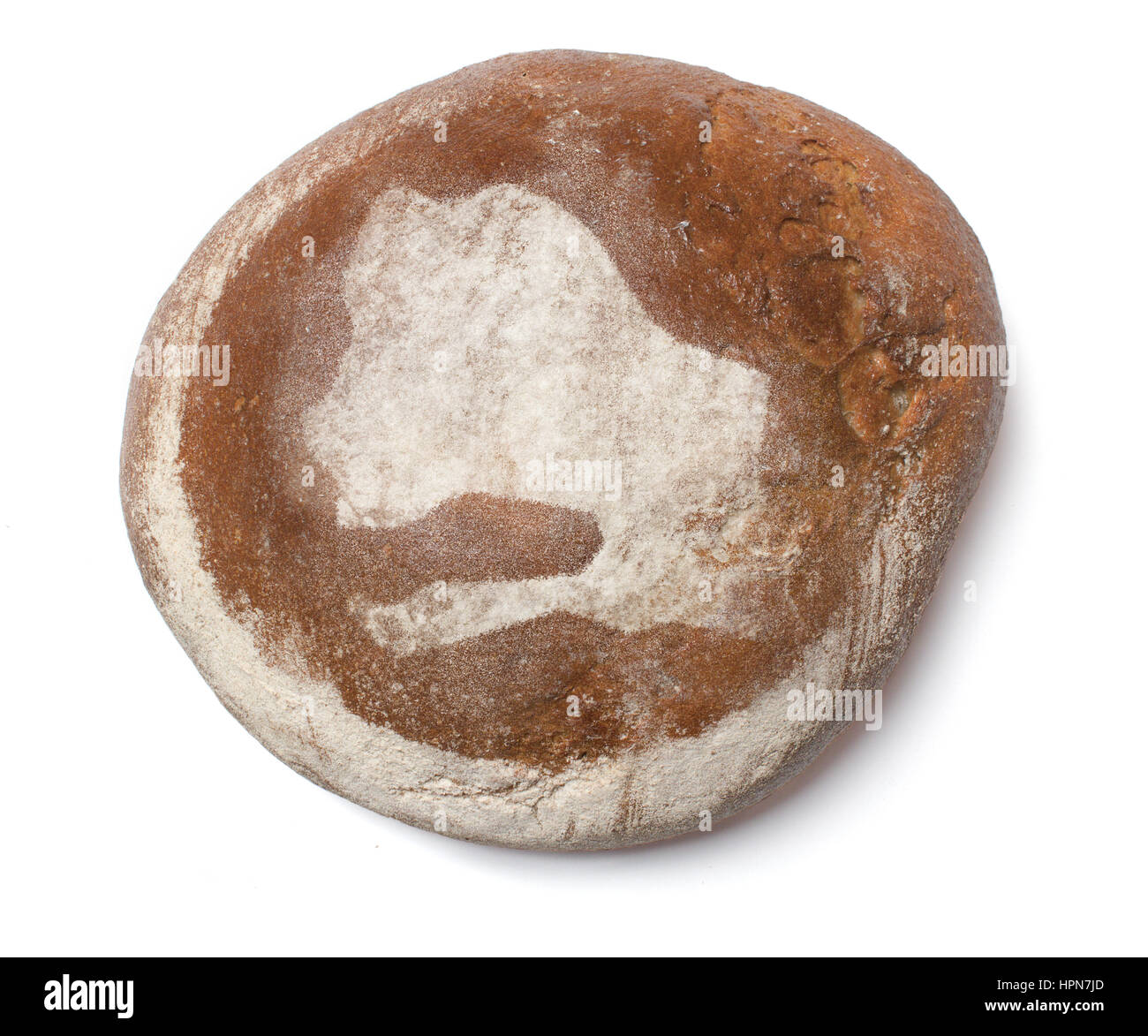 A freshly baked loaf of bread covered with rye flour in the shape of ...