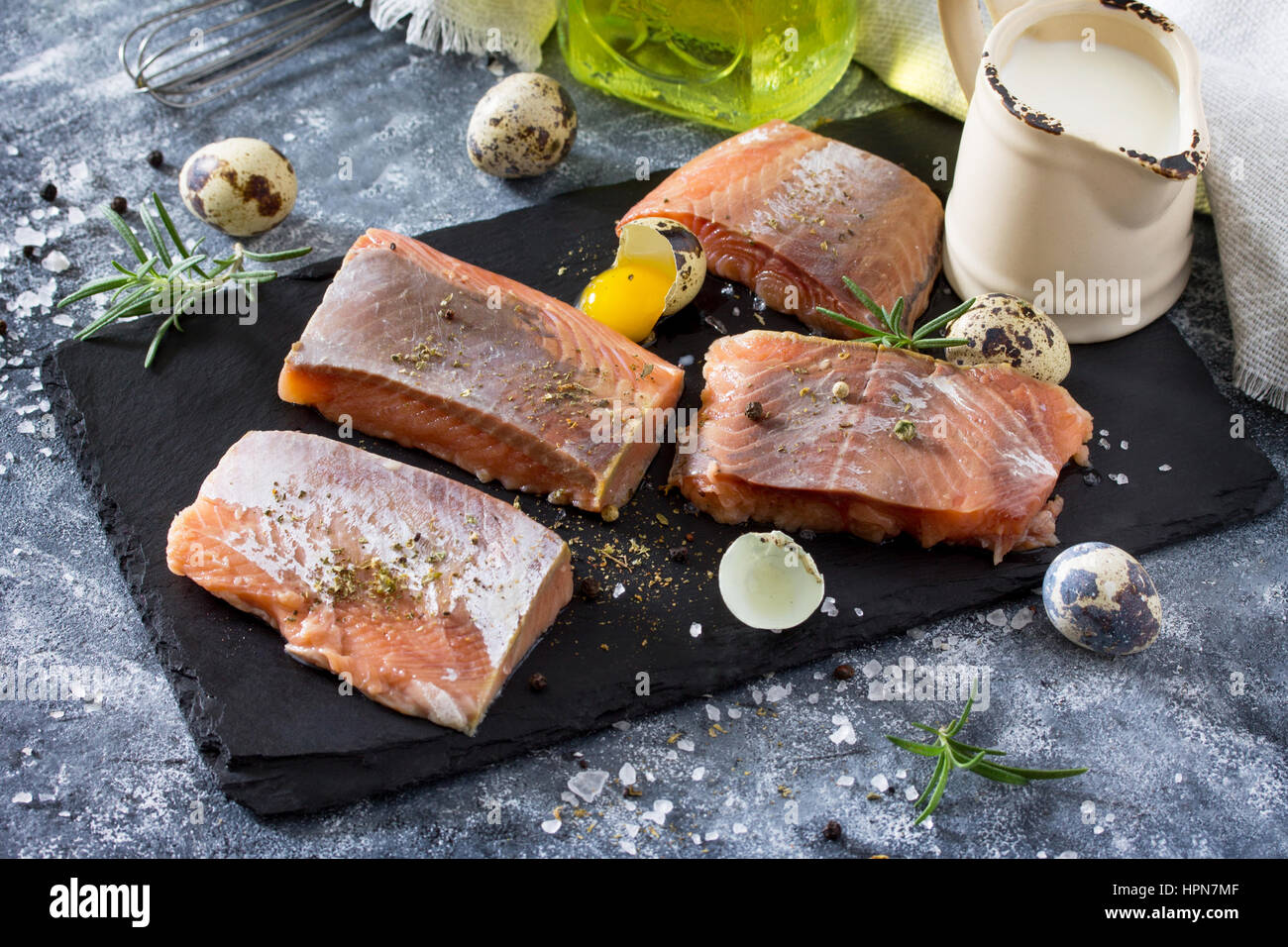 Ingredients for cooking egg omelet stuffed with red fish fillet. The ...
