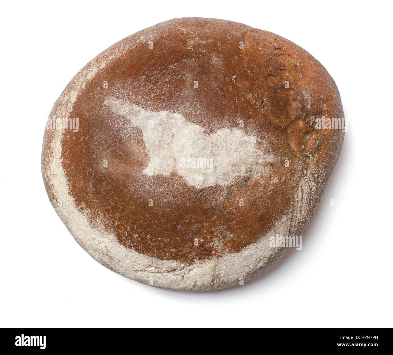 A freshly baked loaf of bread covered with rye flour in the shape of ...