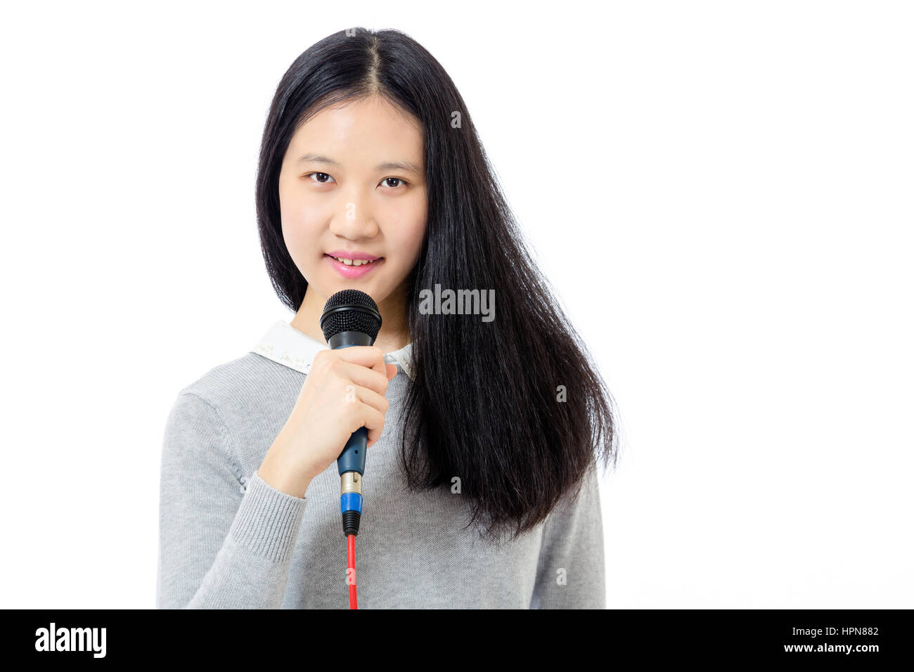 Chinese teenage girl holding microphone Stock Photo - Alamy