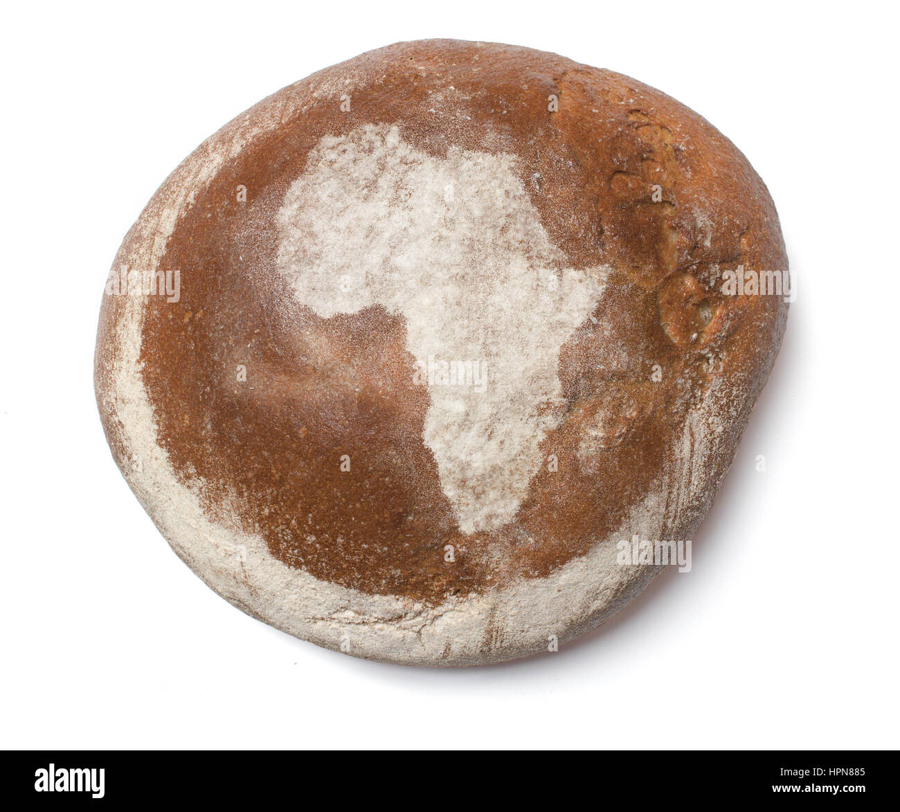 A freshly baked loaf of bread covered with rye flour in the shape of ...