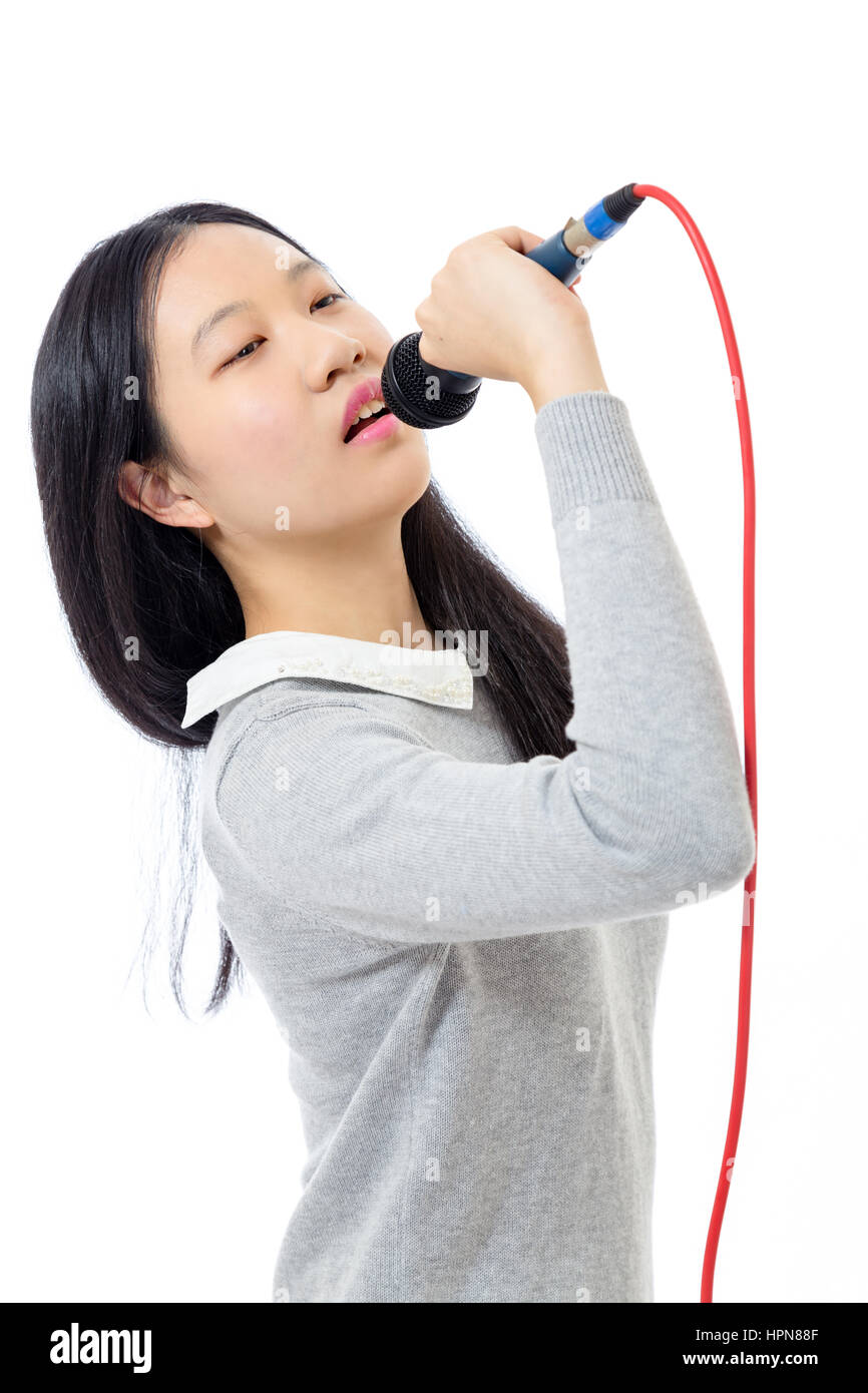 Chinese teenage girl holding microphone Stock Photo - Alamy