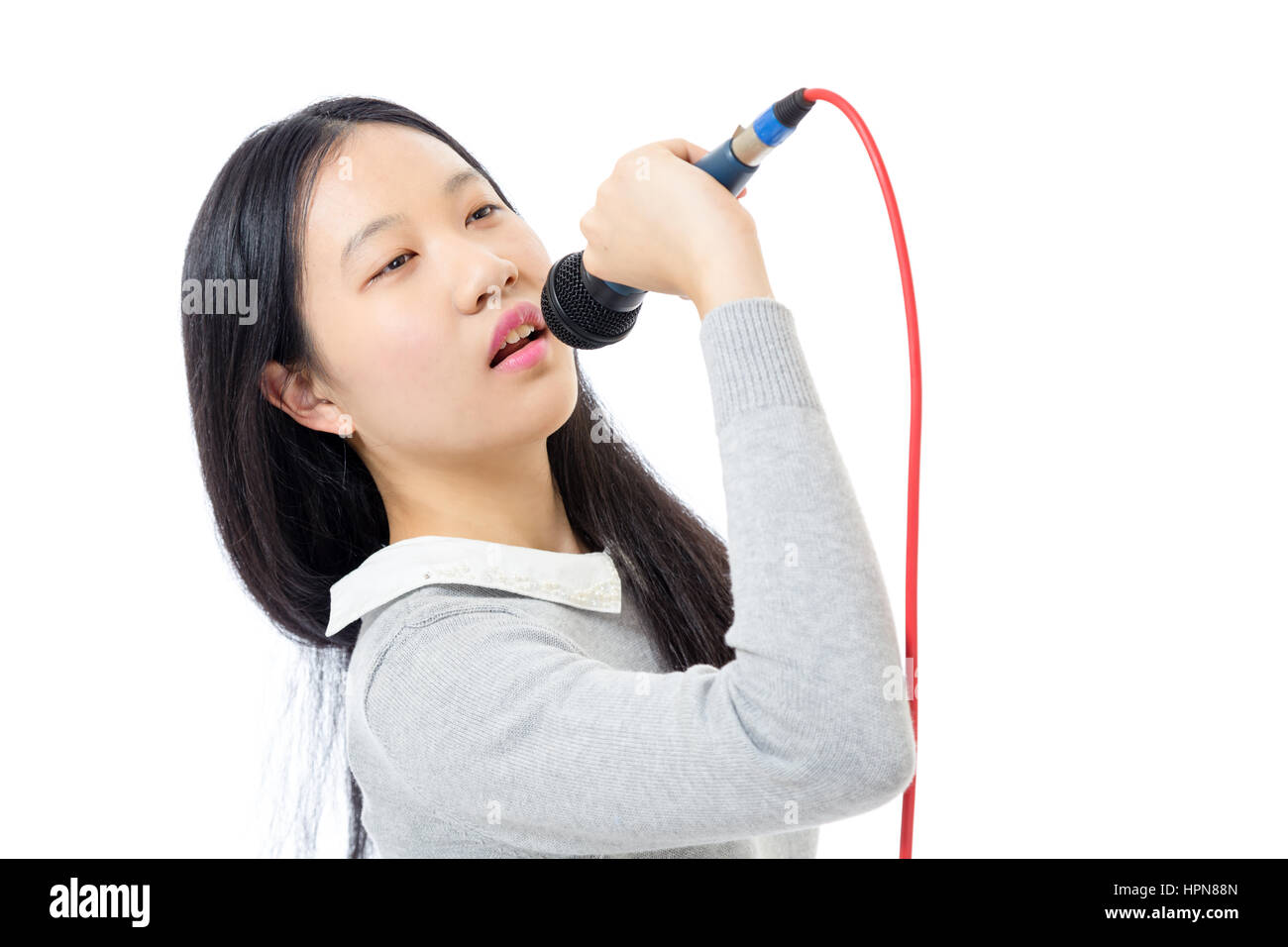 Chinese teenage girl holding microphone Stock Photo - Alamy