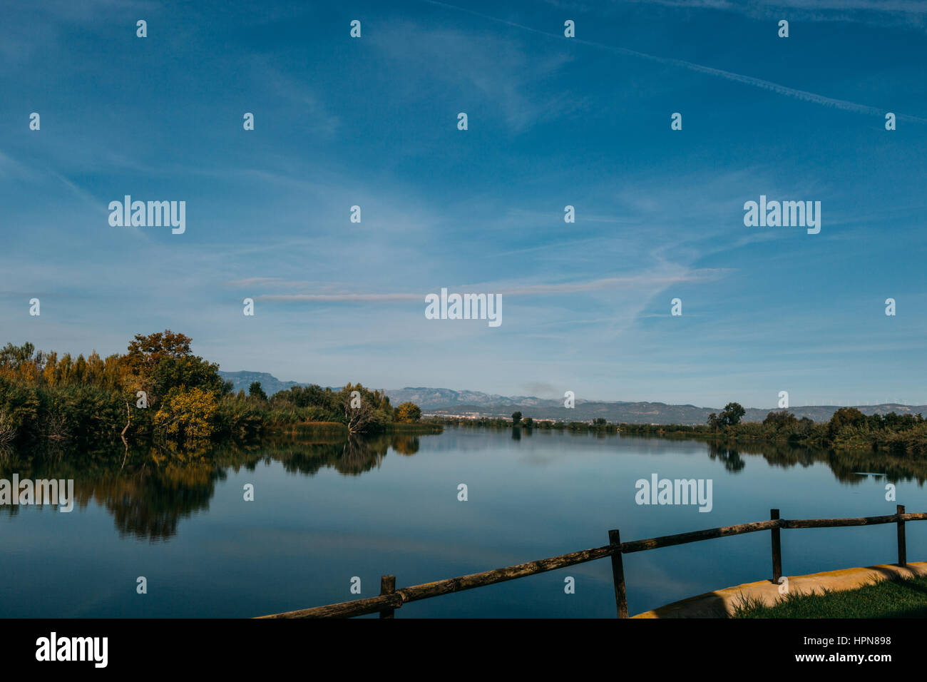 relaxing lake ELBA in spain with a view on the woods from a terrace ...