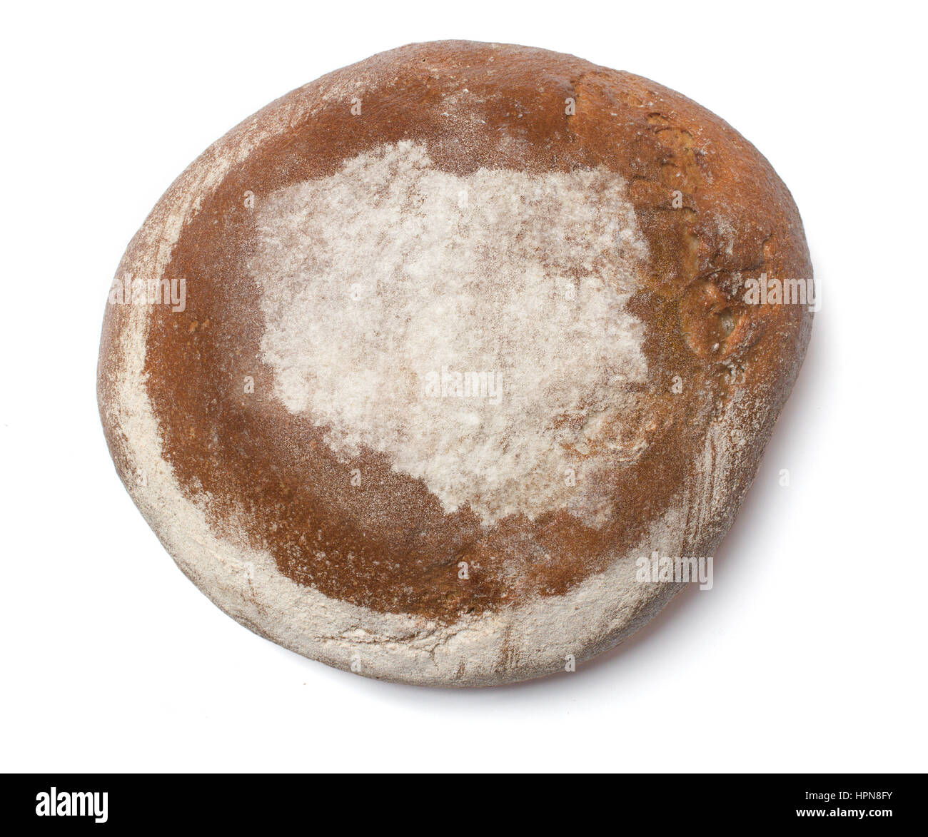 A freshly baked loaf of bread covered with rye flour in the shape of ...