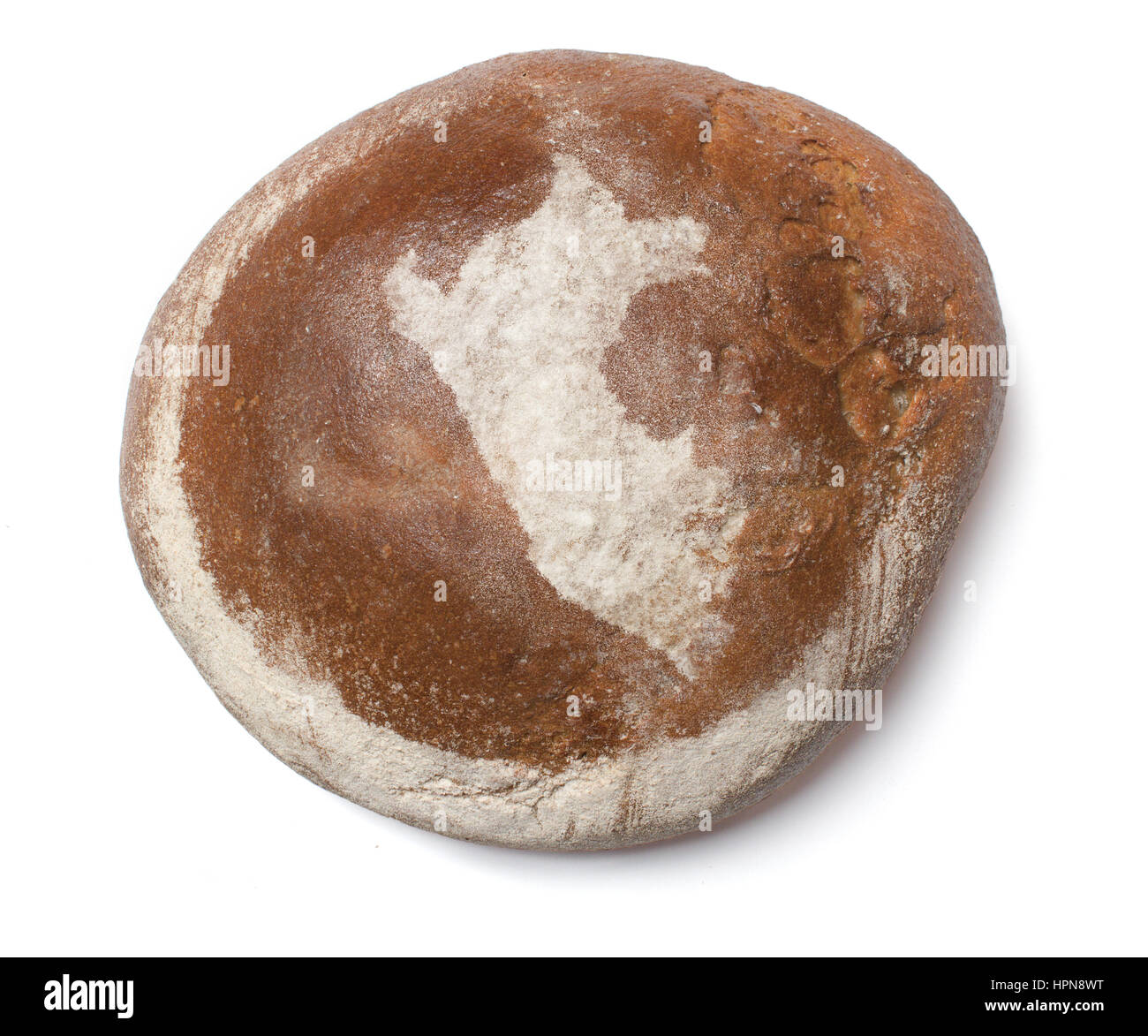 A freshly baked loaf of bread covered with rye flour in the shape of ...