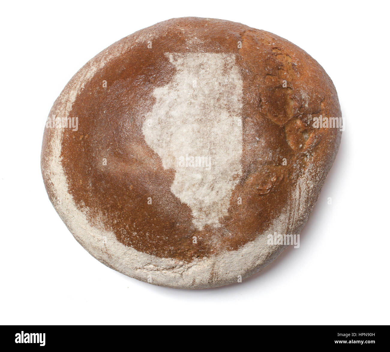A freshly baked loaf of bread covered with rye flour in the shape of ...