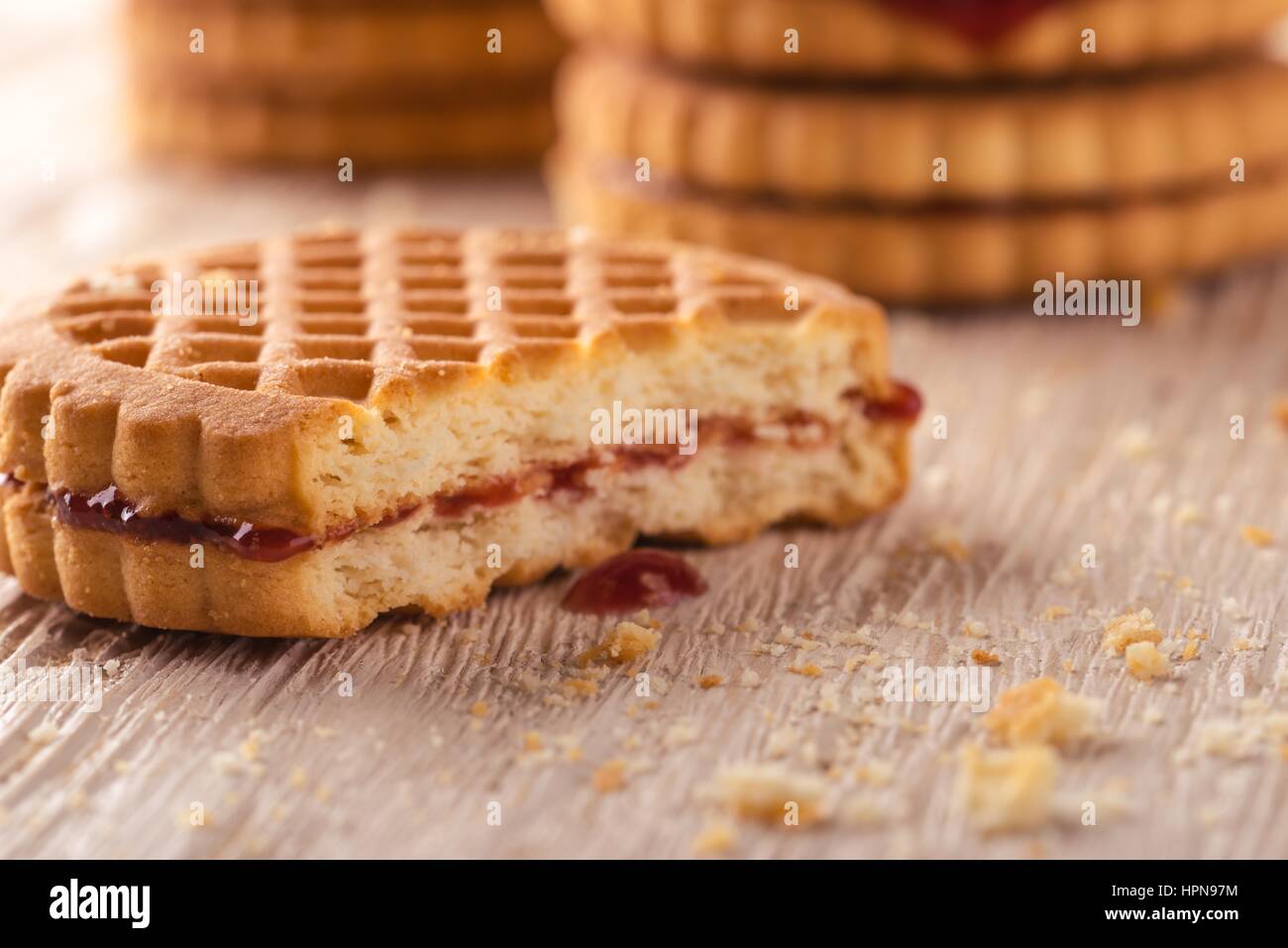 Horizontal photo of several stacks of golden biscuits. Biscuits are ...