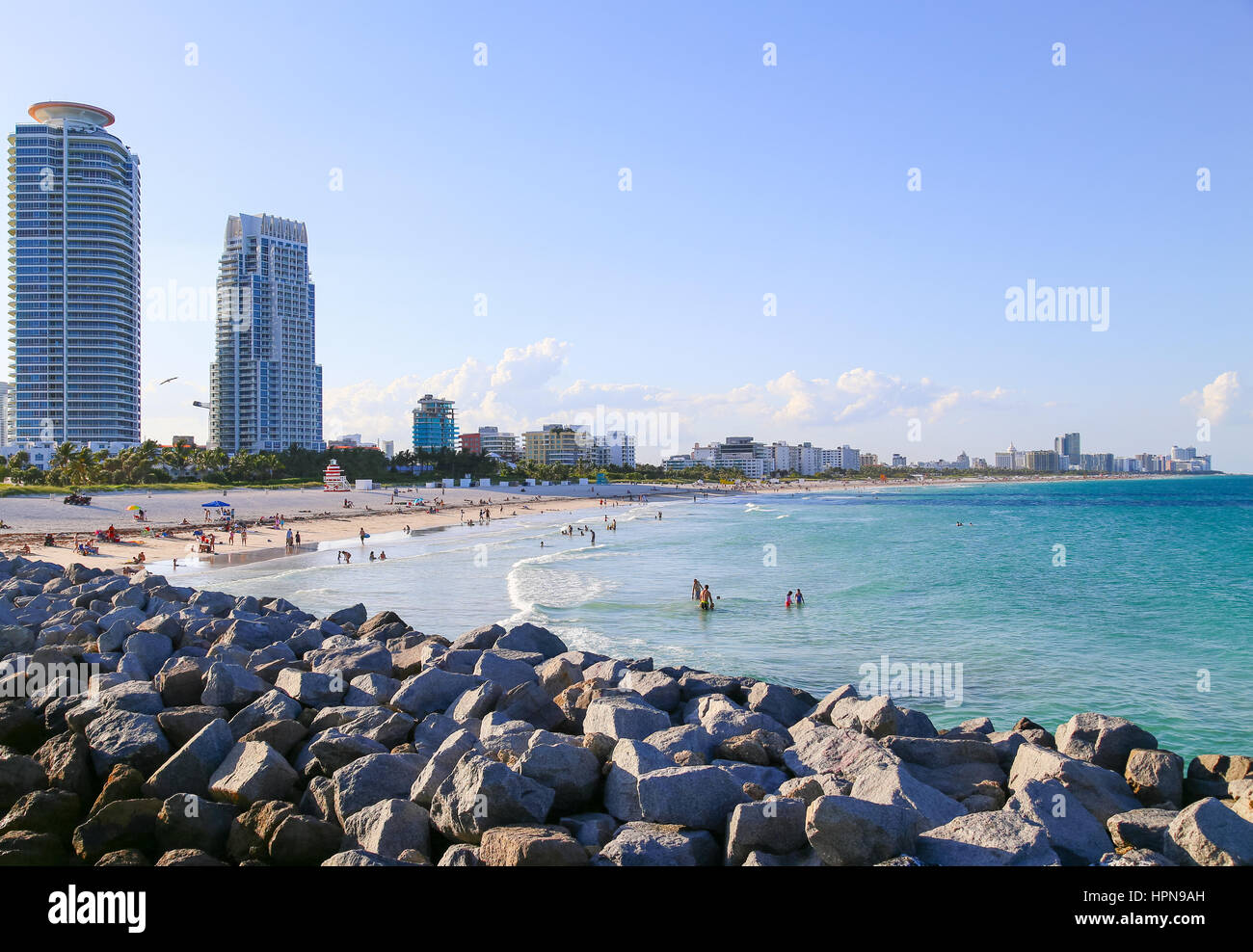 MIAMI BEACH, USA - MAY 9, 2015: People sunbathing and swimming at the ...