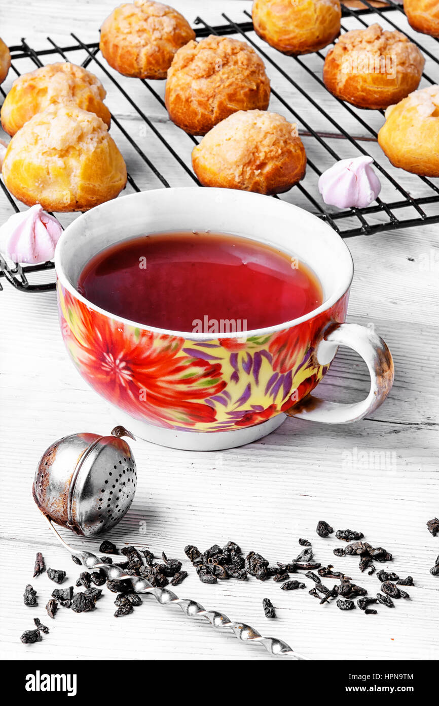 Homemade profiteroles eclairs dessert with cup tea Stock Photo - Alamy