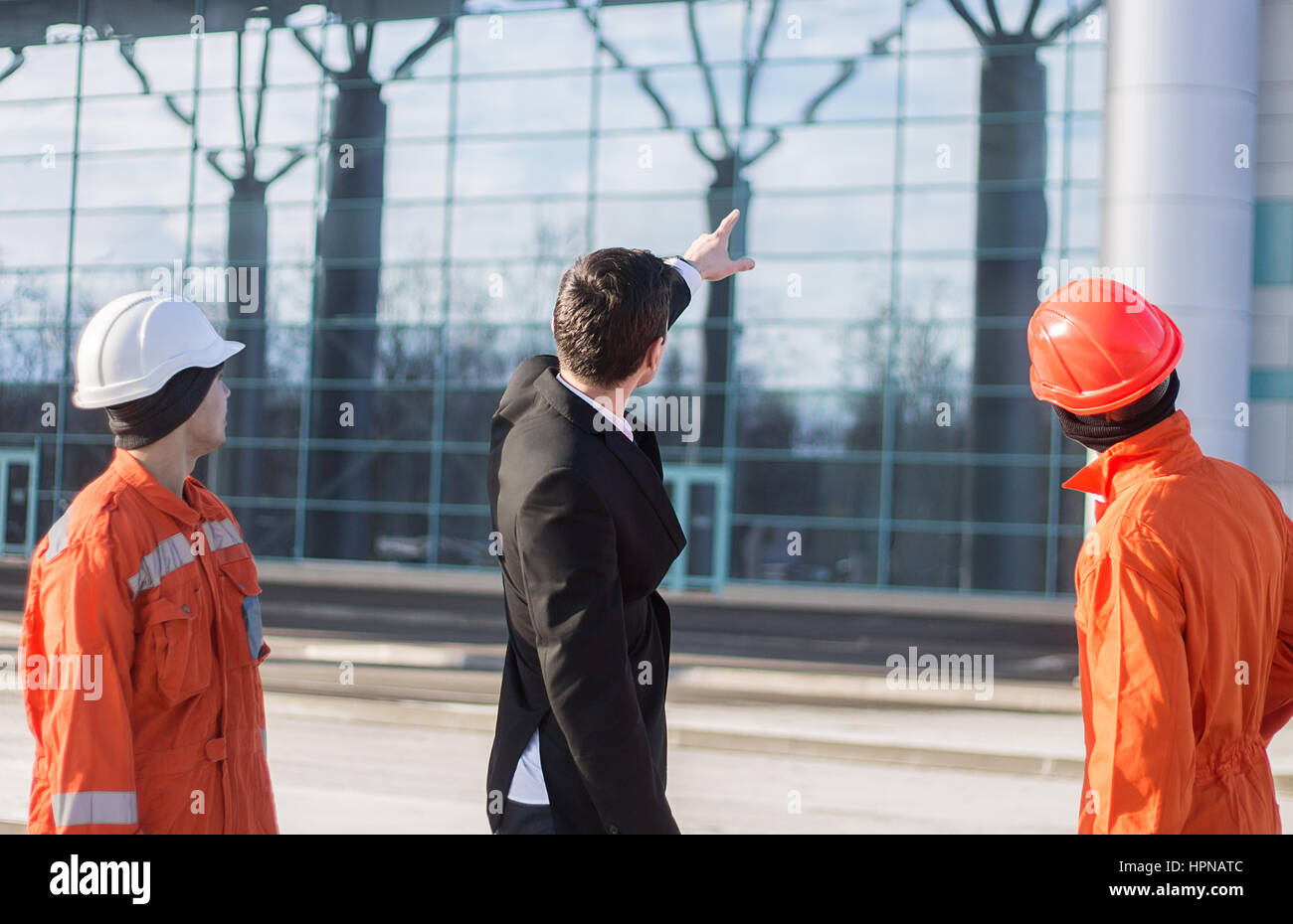 boss or Chief showing a construction project to young team of engineers ...
