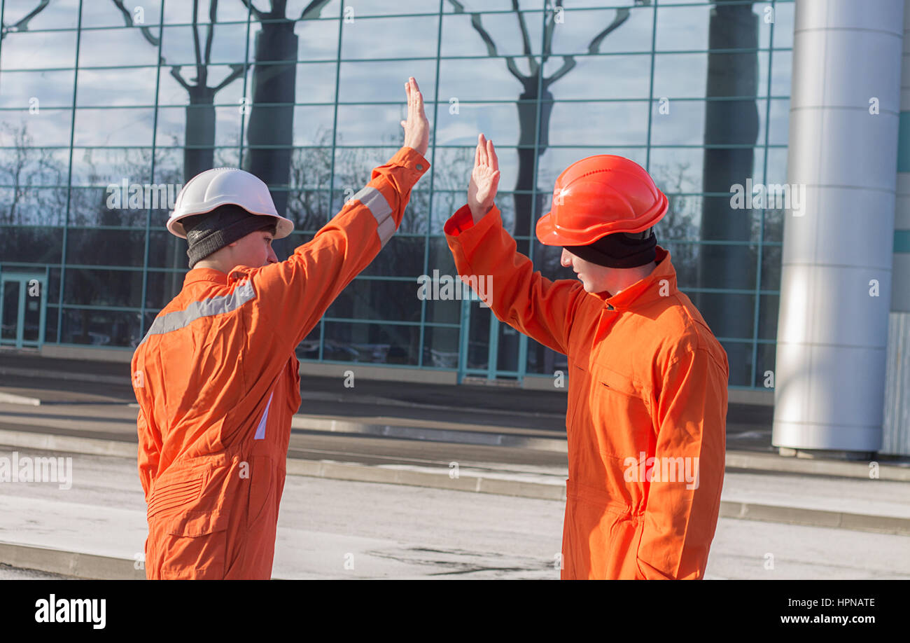 team of young engineers giving high five for motivation. They wear ...