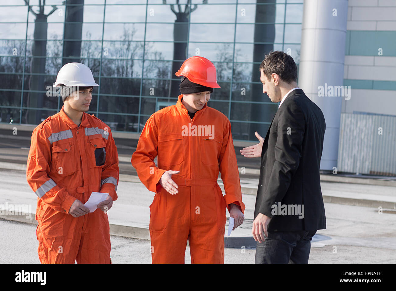 boss or Chief handshaking with workers engineers after work. Good job ...