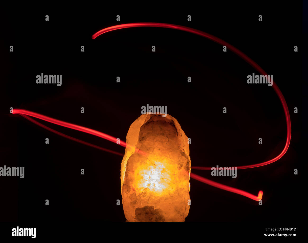 red aura surrounding salt rock crystal lamp Stock Photo - Alamy