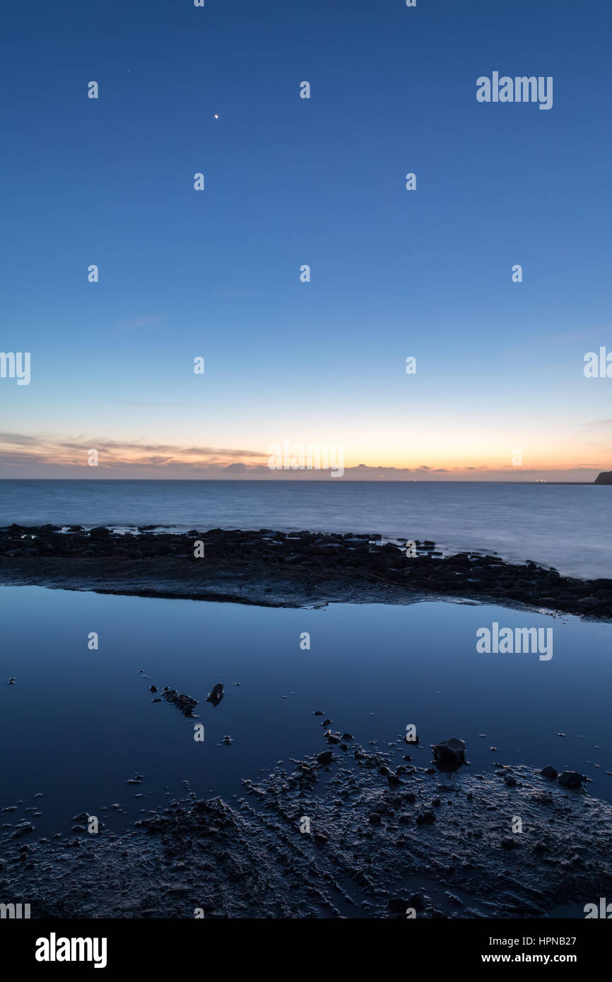 reflections in pudde at night on beach Stock Photo - Alamy