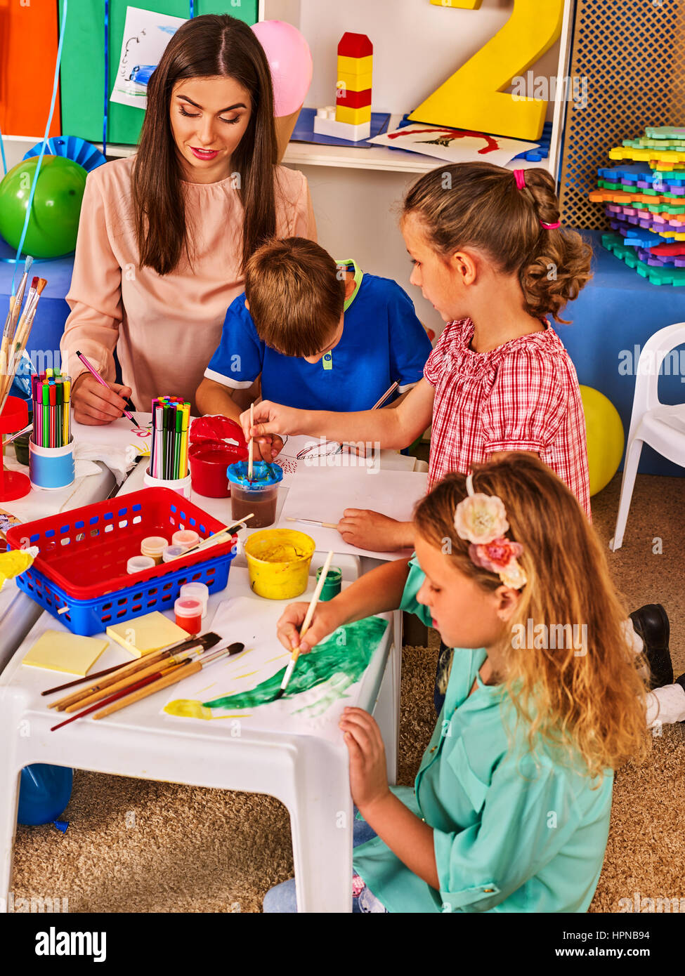 Children painting and drawing together . Craft lesson in primary school ...