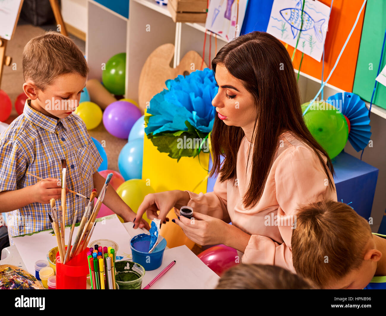 Children painting and drawing together . Craft lesson in primary school ...