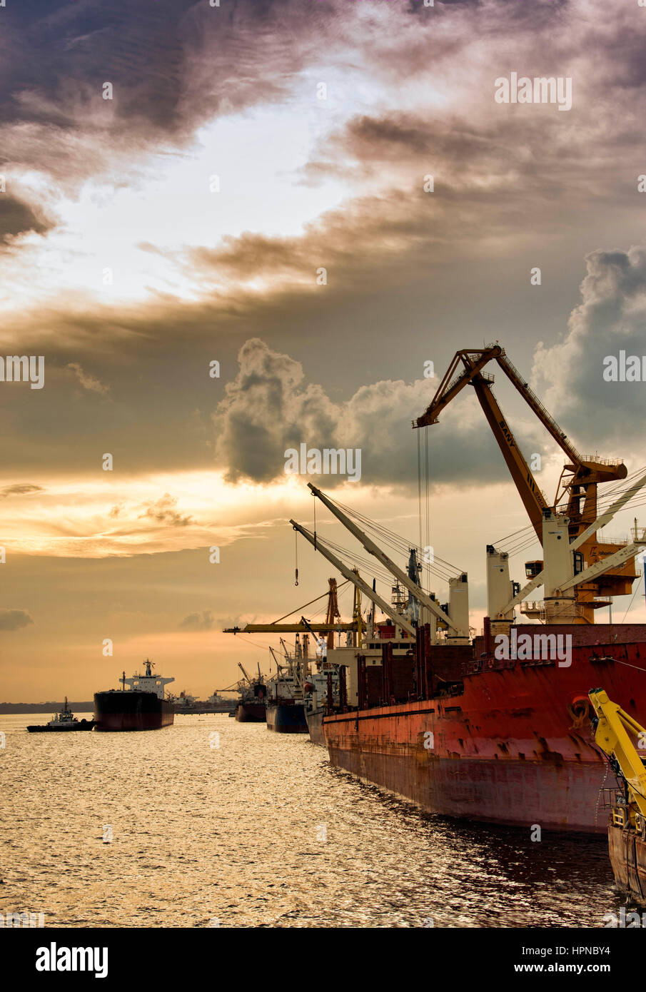 vessel berthing to port with tug boat pushing the vessel to along side ...