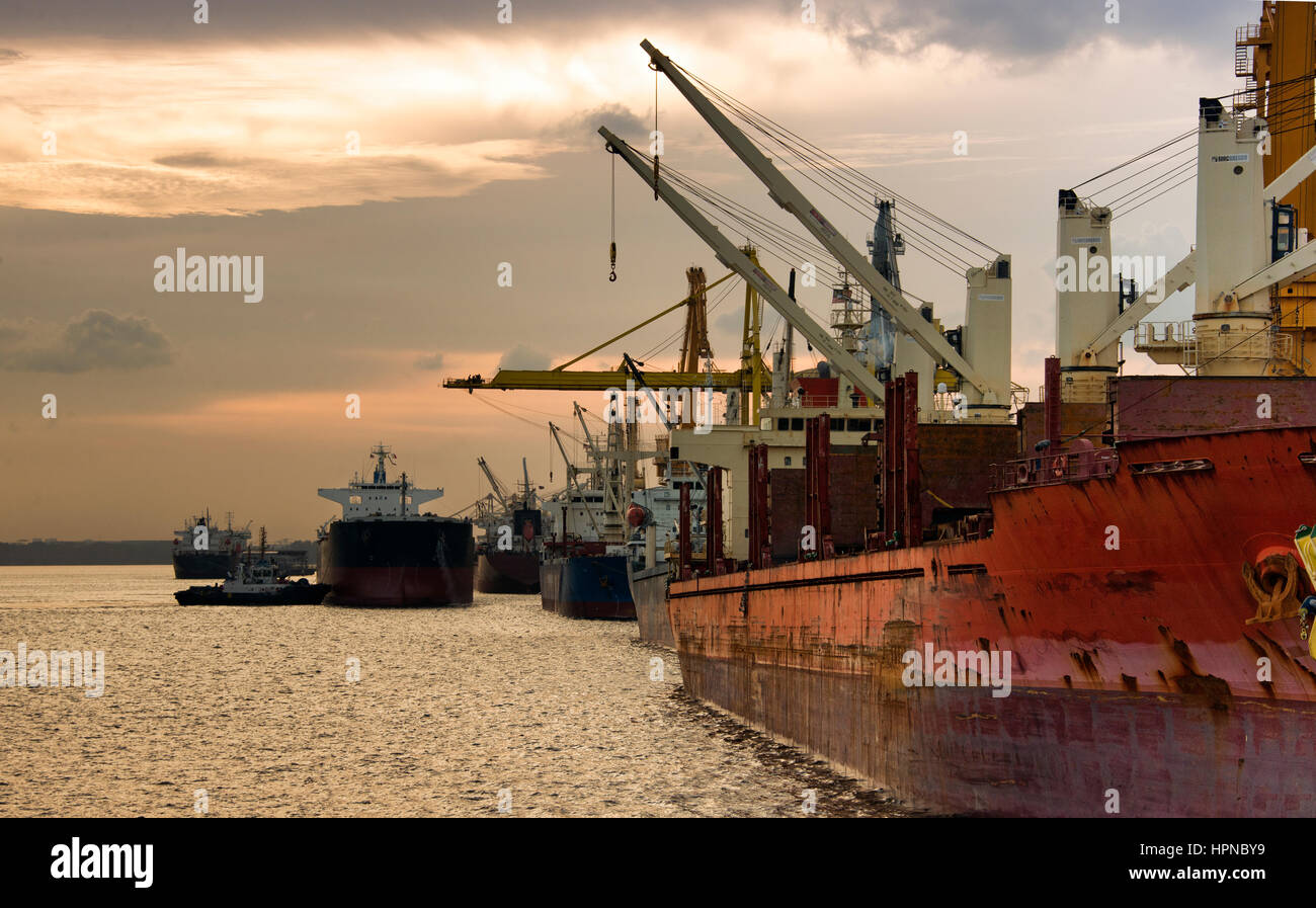 vessel berthing to port with tug boat pushing the vessel to along side ...