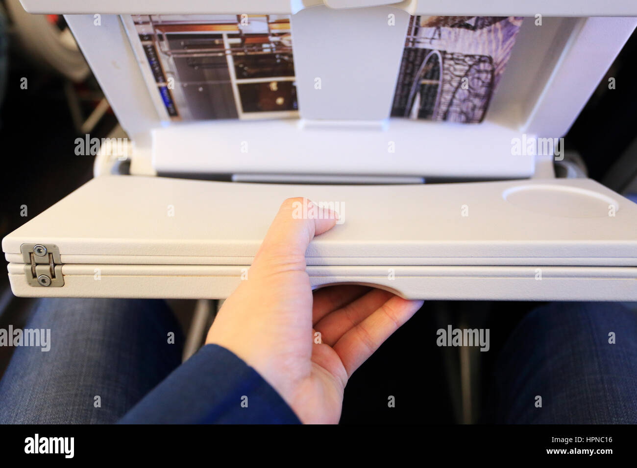 Unlocked white passenger airplane table in chair Stock Photo - Alamy