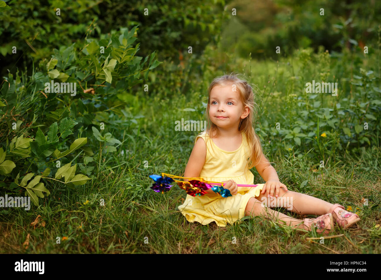 Girl with a pinwheel hi-res stock photography and images - Alamy