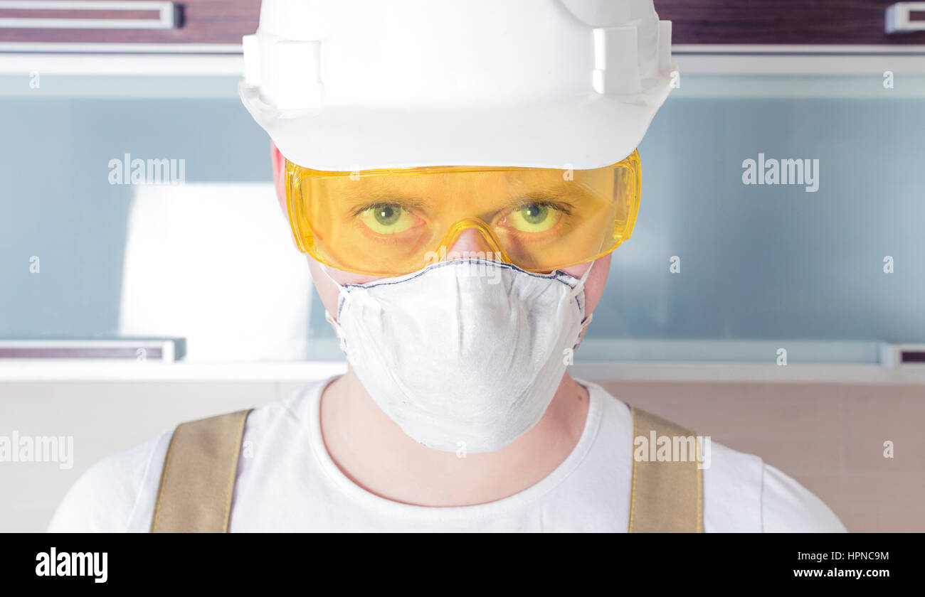 Worker wearing safety glasses respirator helmet. Worker wearing ...