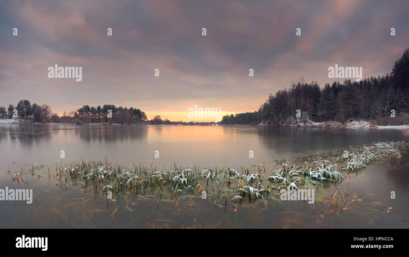 Landscape of frozen lake. Thin transparent ice on the water. Morning ...