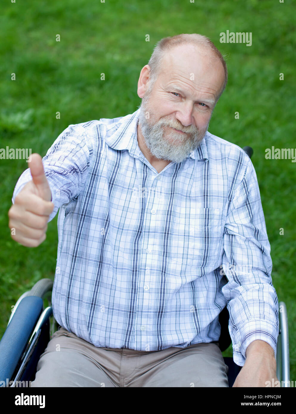 Handicapped elderly man sitting in a wheelchair Stock Photo - Alamy