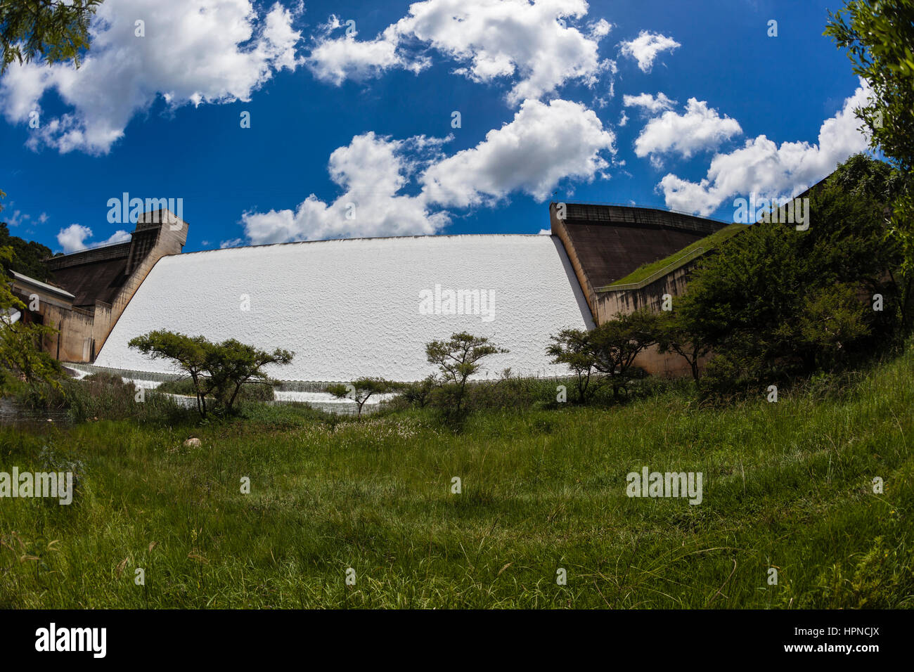 Inanda Dam fill to capacity and water flowing over the high wall Stock ...