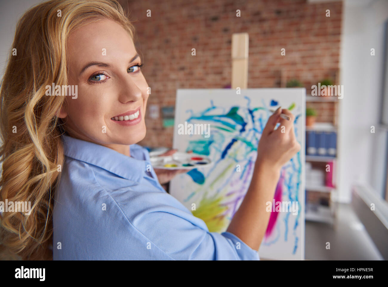 Portrait of cheerful young artist Stock Photo - Alamy