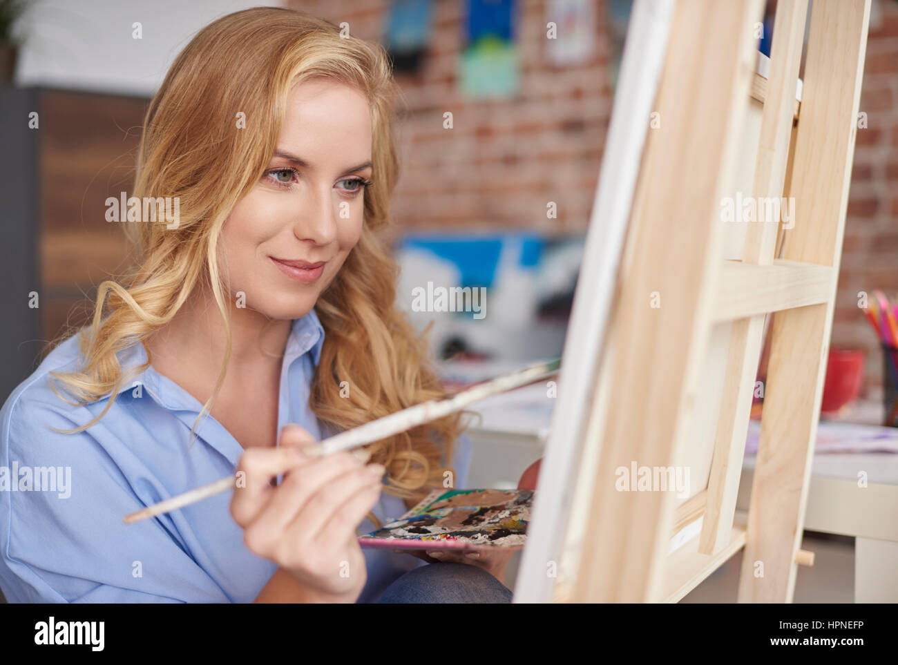 Woman painting in artists studio Stock Photo - Alamy