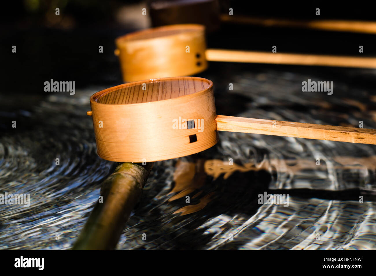 The ladles used to cleanse one's impurities before praying at a Shinto ...