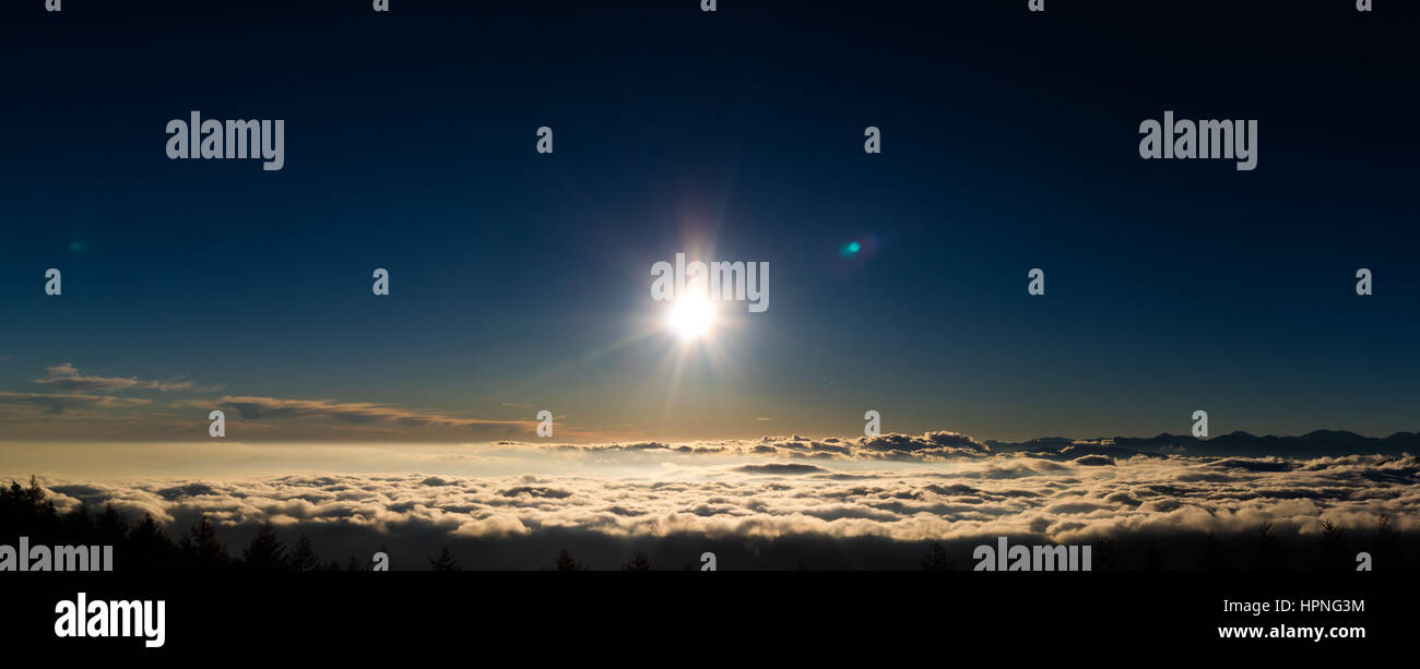 The sun setting on a sea of clouds. Viewed from halfway up Mt. Fuji in ...