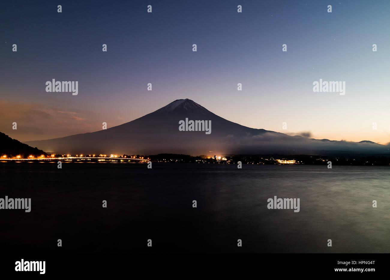 A view of mount Fuji in Japan, as the sun goes down it starts to look ...