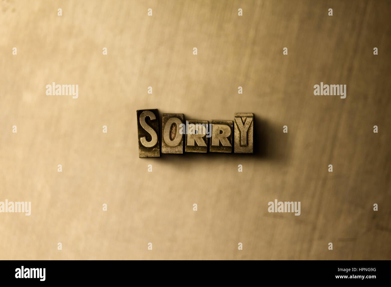 SORRY - close-up of grungy vintage typeset word on metal backdrop ...