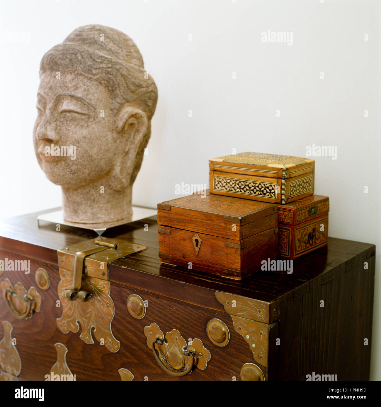A sculpture of Bhudda on a chest Stock Photo - Alamy