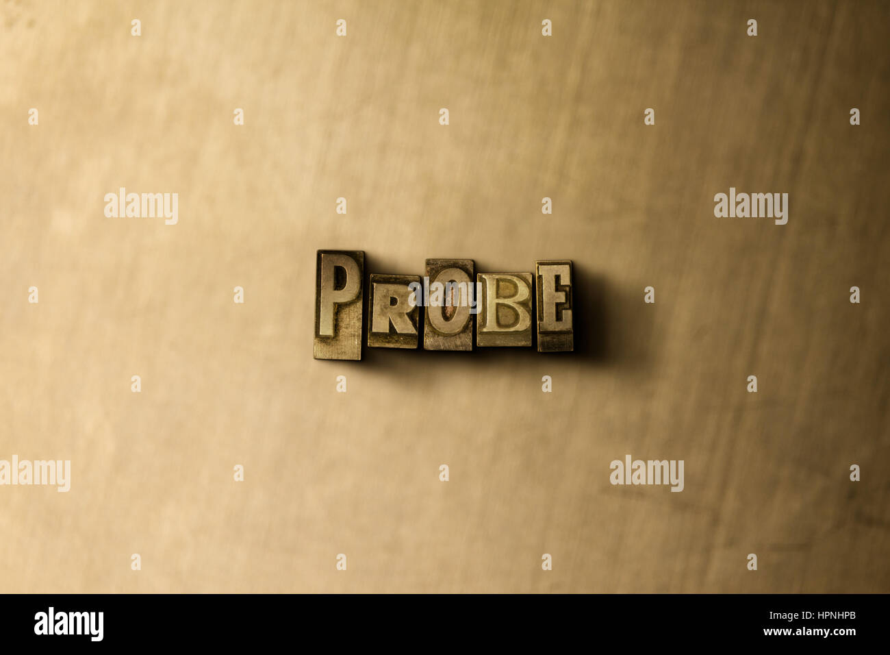 PROBE - close-up of grungy vintage typeset word on metal backdrop ...
