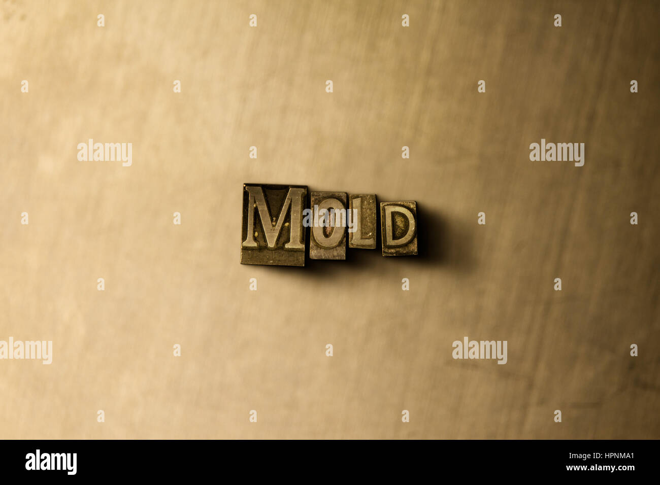 MOLD - close-up of grungy vintage typeset word on metal backdrop ...