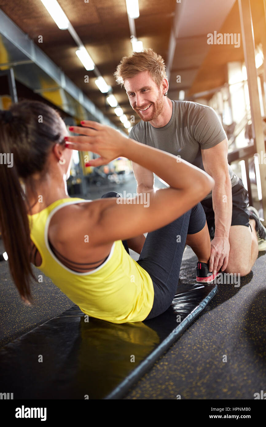 Young girl exercises with trainer in gym Stock Photo - Alamy