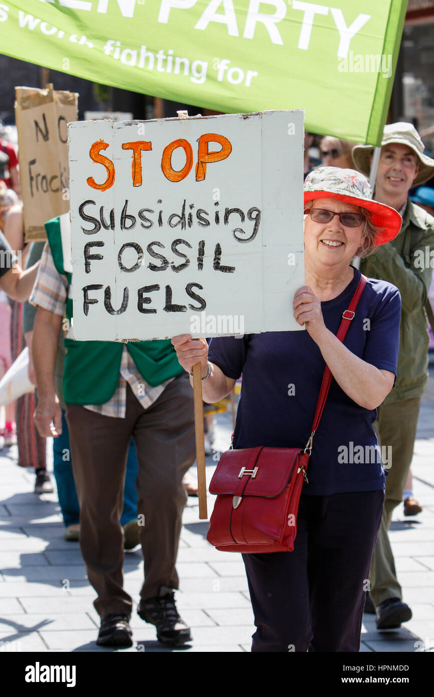 Climate change protesters carrying signs and placards are pictured as ...
