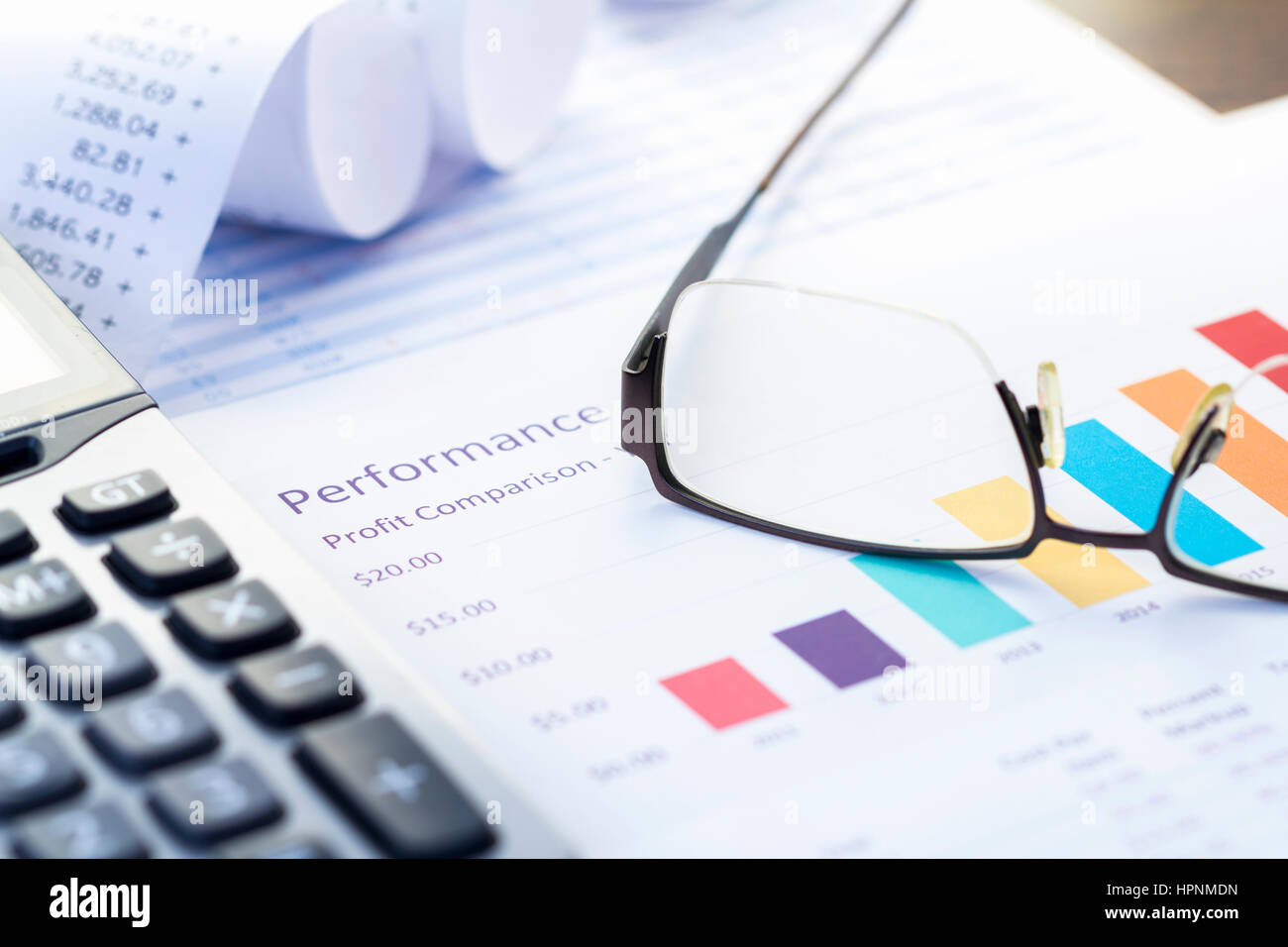 Business performance analysis with colorful bar graph and calculator ...