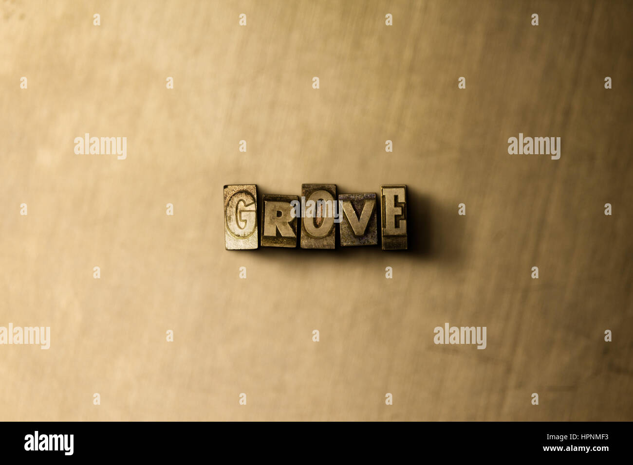 GROVE - close-up of grungy vintage typeset word on metal backdrop ...