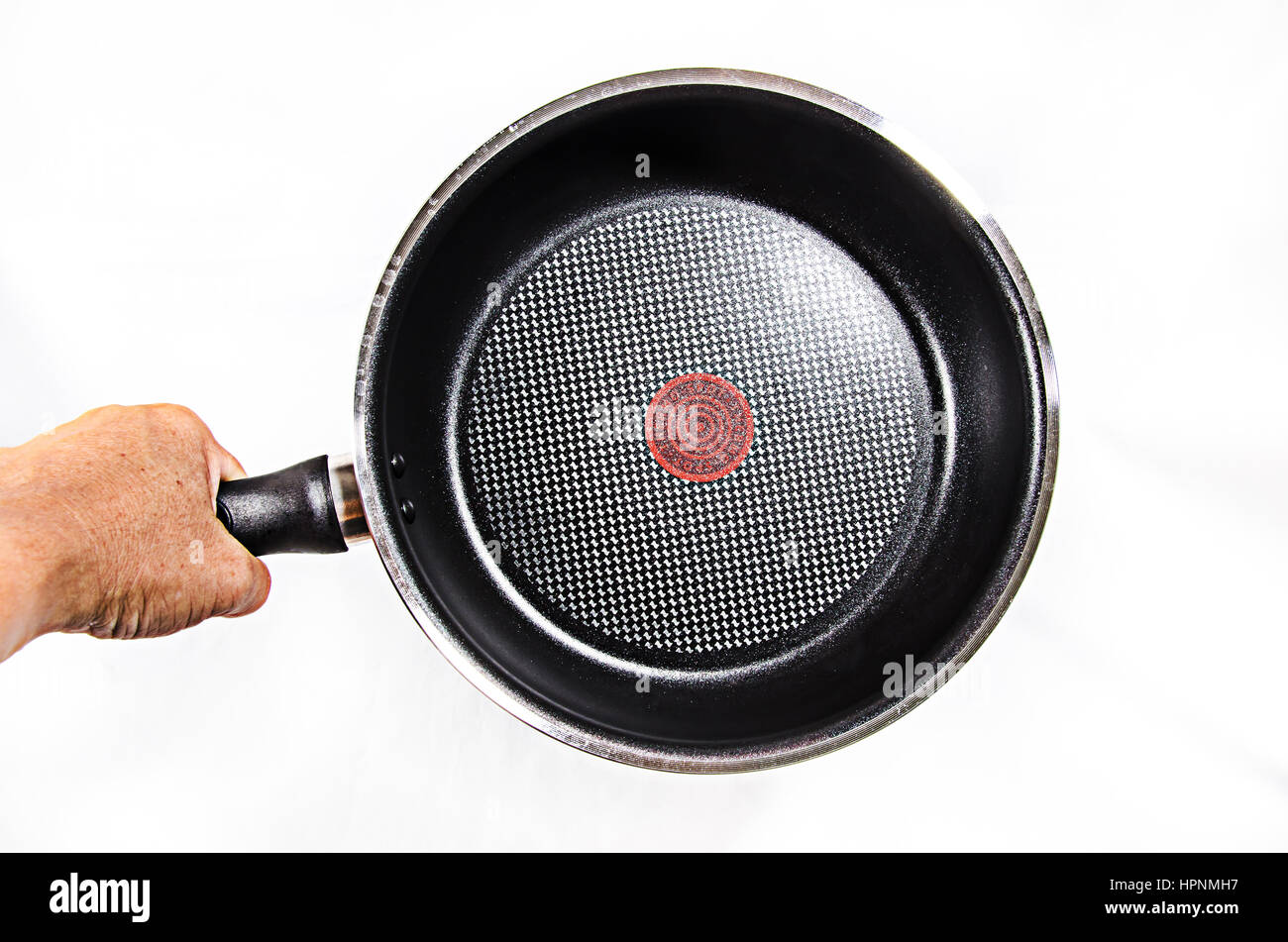 hand for cook with black pan on white background Stock Photo - Alamy