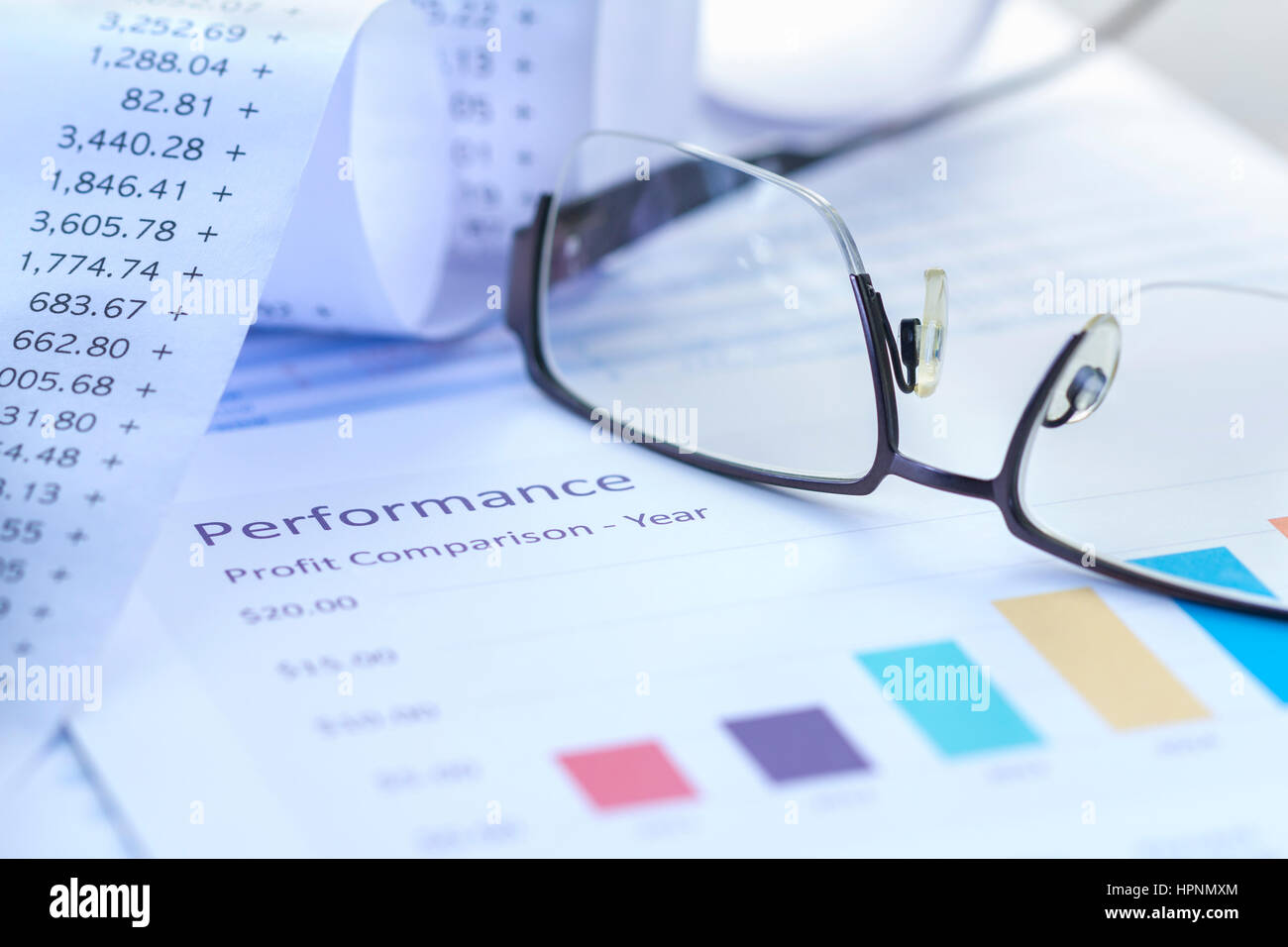Business performance analysis with colorful bar graph and eyeglasses in ...