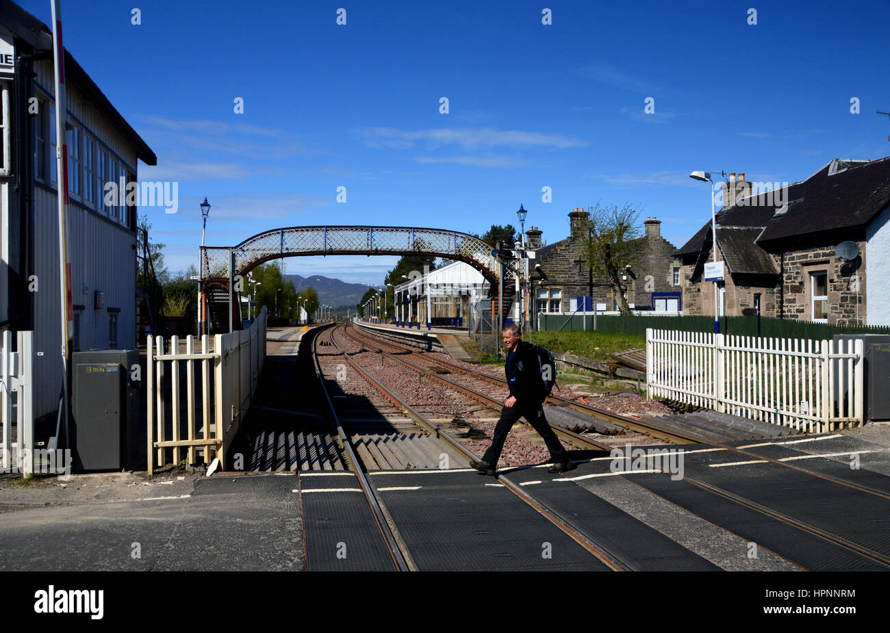 Male Hiker Walking Across the Level Crossing at Kingussie Train Station ...