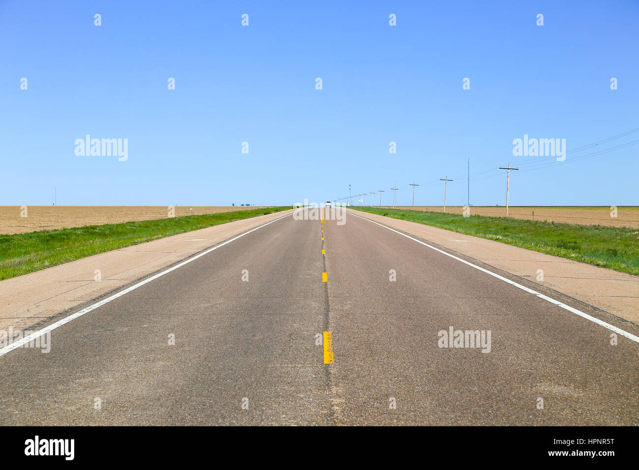 Highway going through fields near Lakin in Kansas, USA, with ...